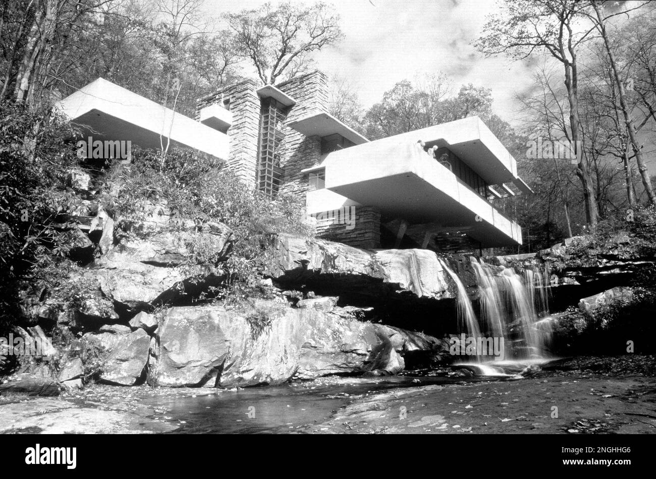 Water cascades over a rock ledge beneath Fallingwater, designed by ...