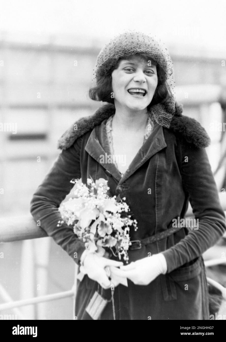 Stage and film actress Theda Bara poses with a flower corsage on April ...