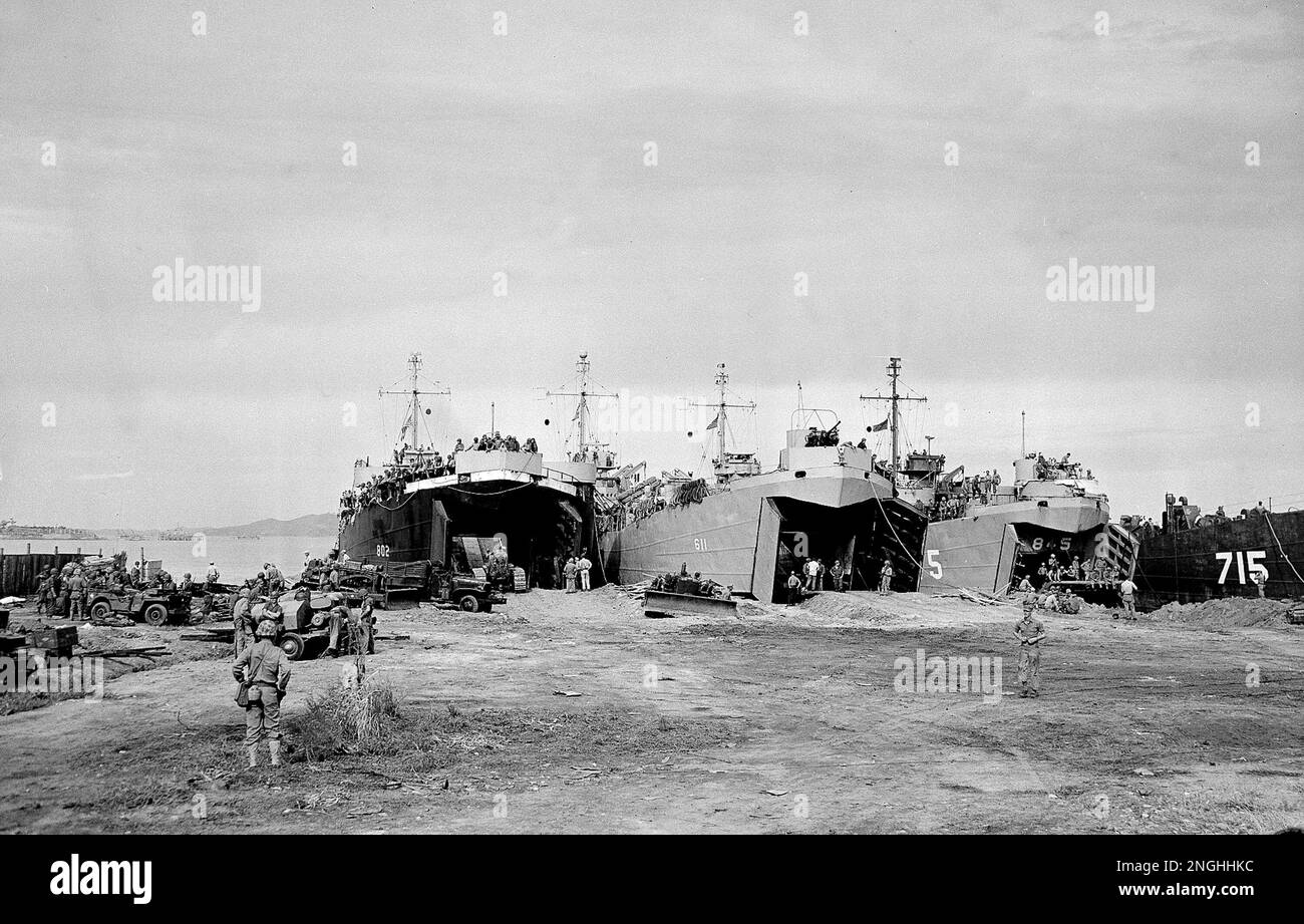 Equipment is unloaded from landing ship tanks (LST) during operations ...