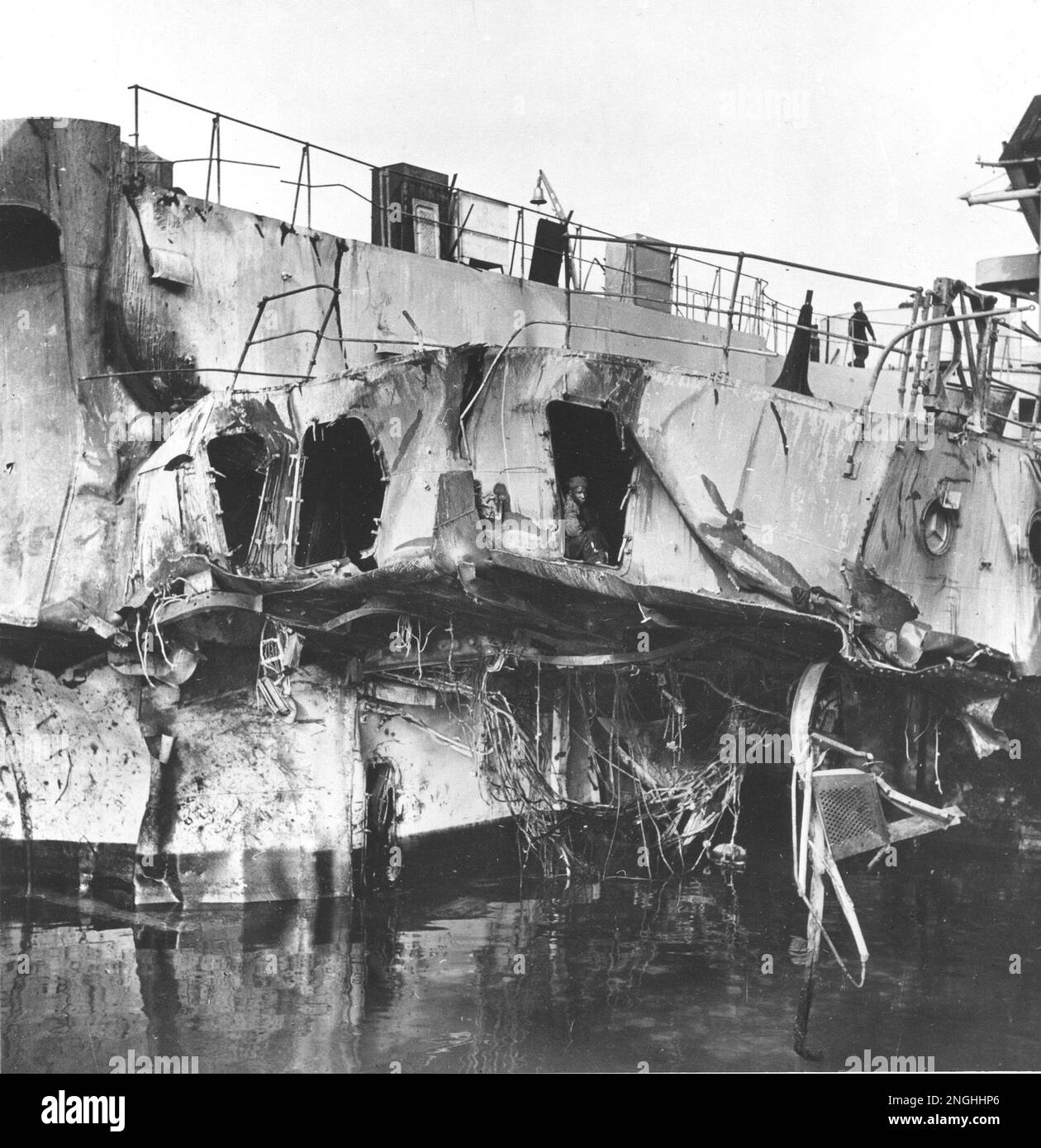 A Moroccan wearing a fez peers through an aperture in the hull of the ...