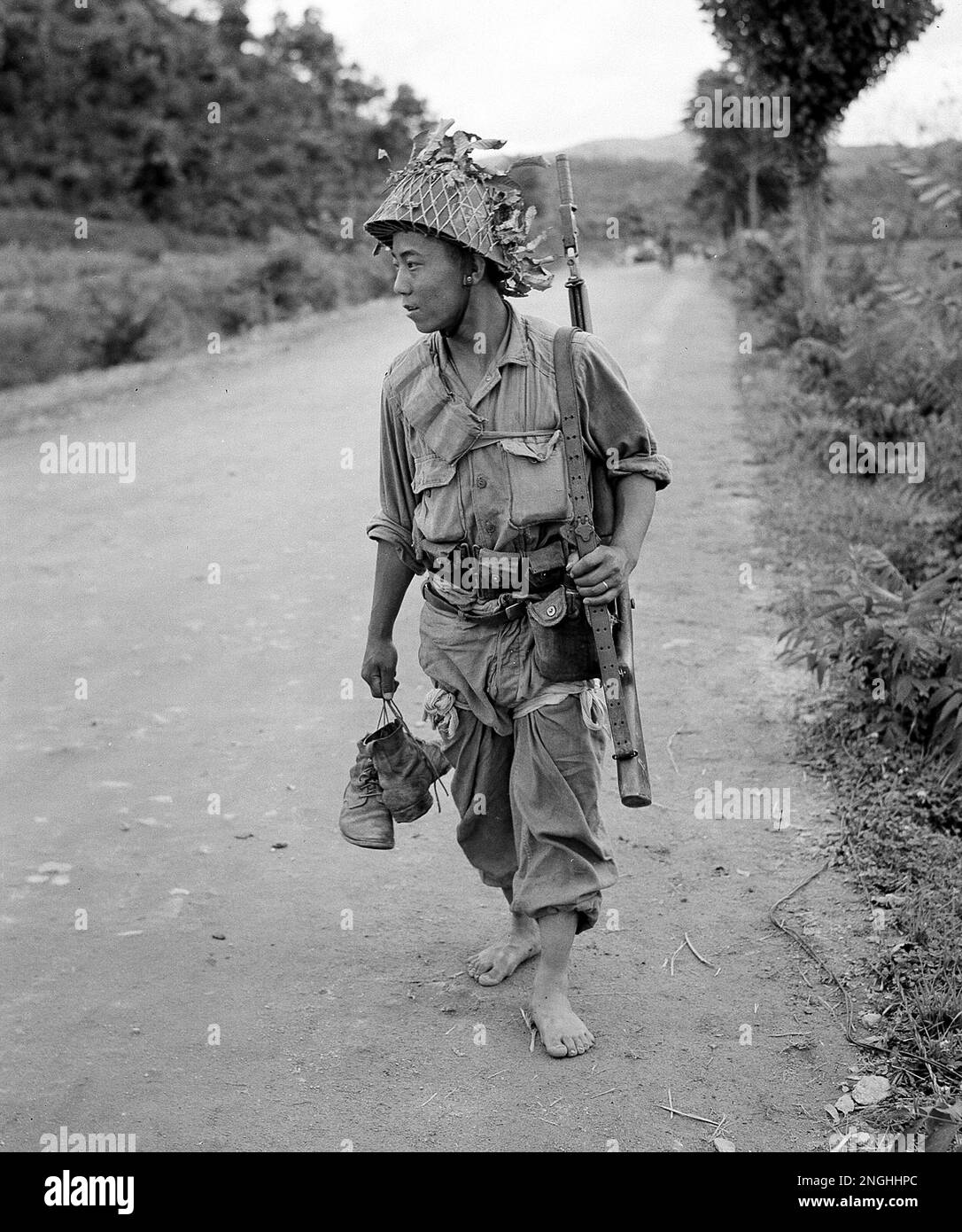 A Republic of Korea (ROC) soldier carries his rifle in one hand and his ...
