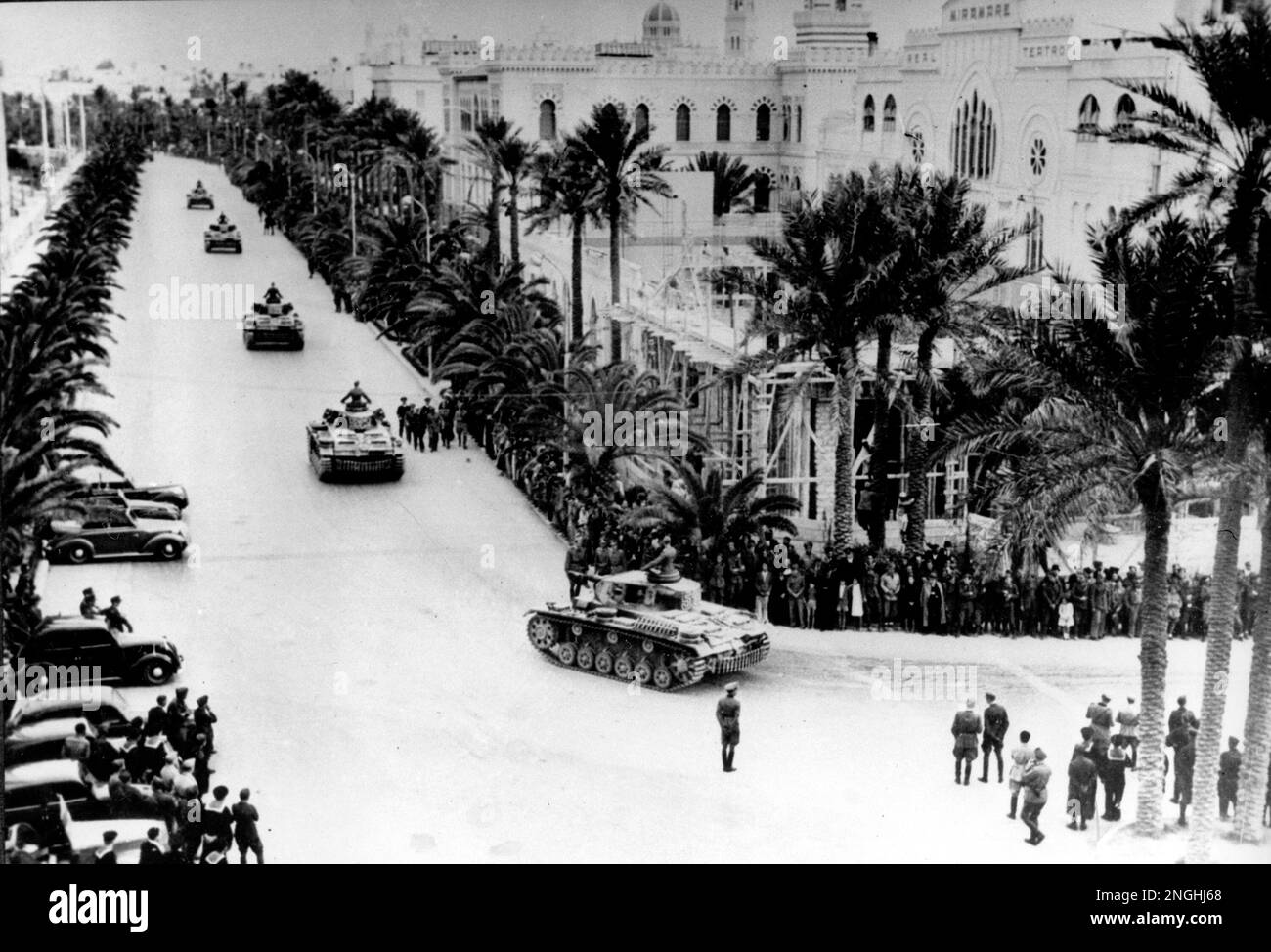 German tanks roll along a street in Tripoli en route to the battle line ...