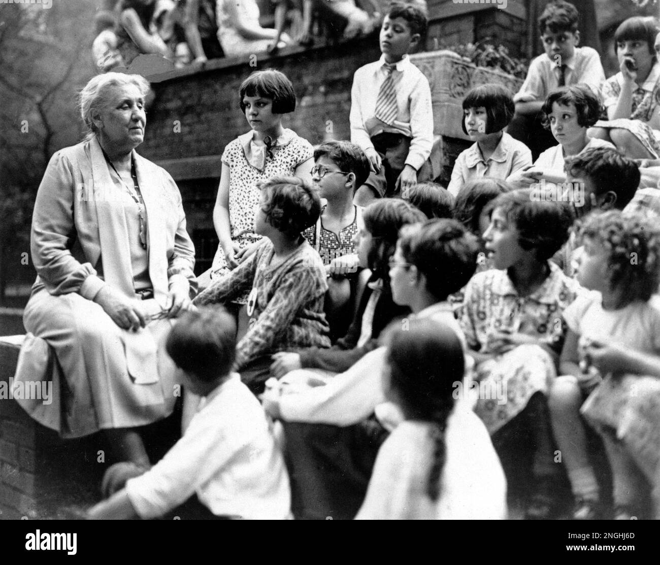 Jane Addams talks with a group of young people who are visiting her ...
