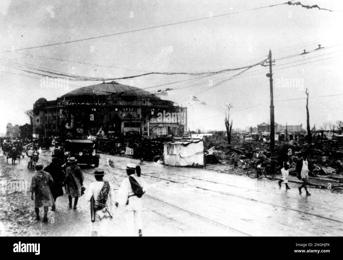 People walk in the devastated area of Yuoguku in Tokyo, Japan, after ...