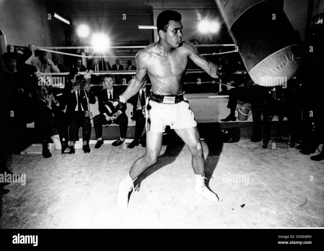 World heavyweight champion Muhammad Ali trains on the punching bag at a ...