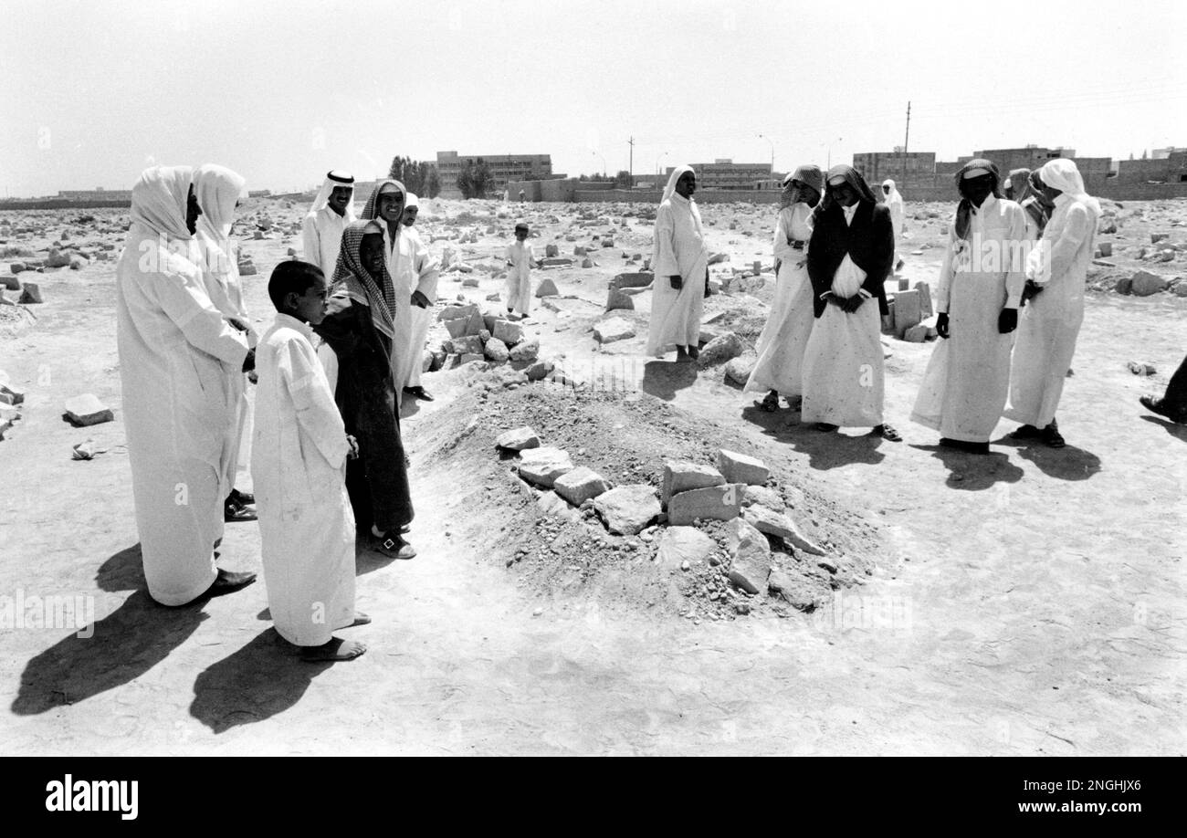 Saudi Arabian men visit the grave of King Faisal, ibn Abd al-Aziz, on ...