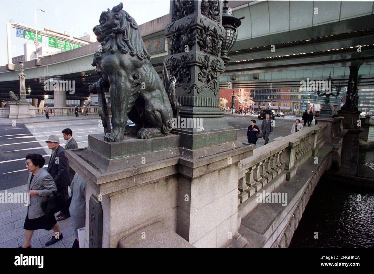 Tokyo residents cross the nearly century-old Nihonbashi Bridge spanned ...