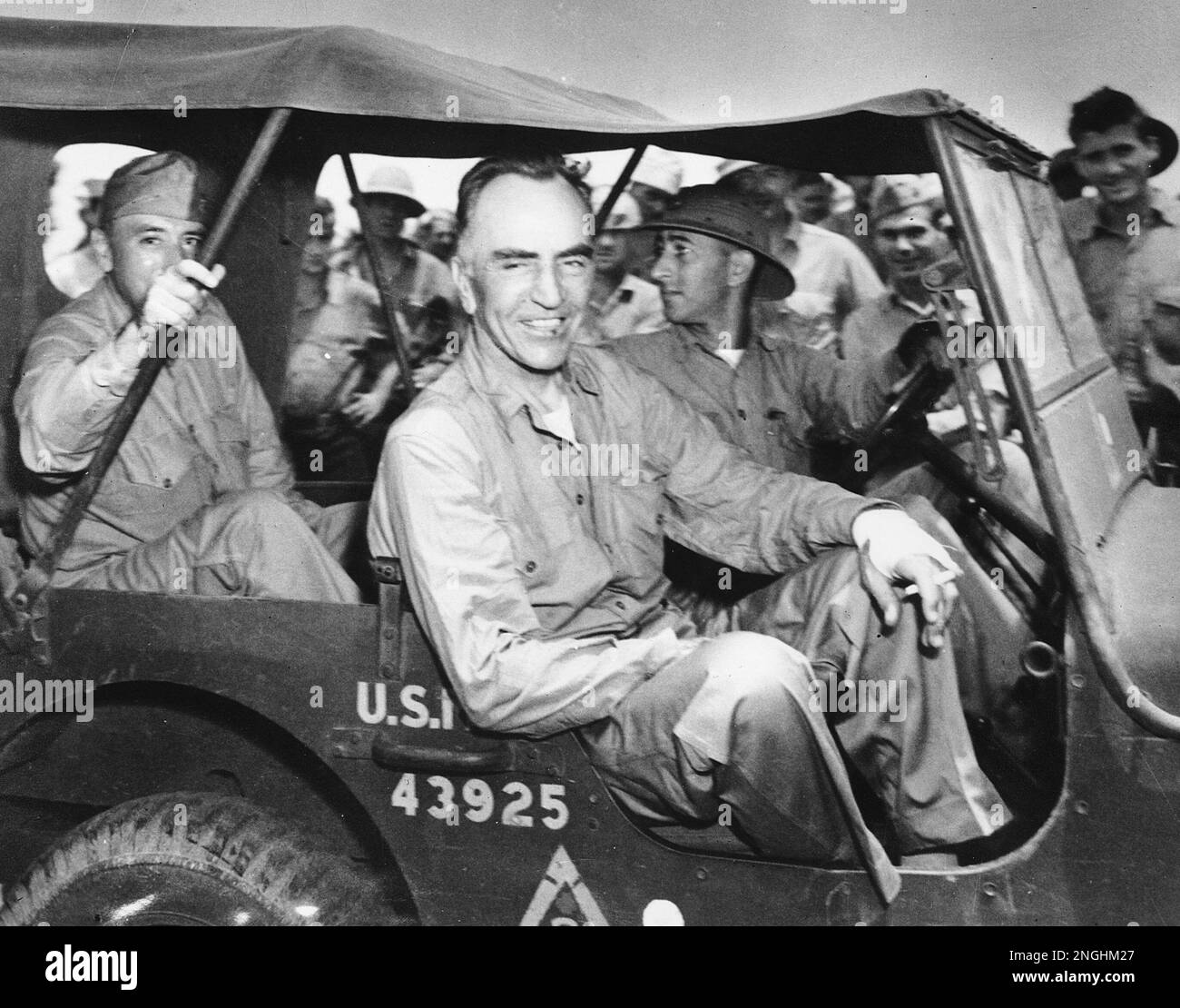 U.S. Capt. Eddie Rickenbacker grins after being rescued as he is driven ...