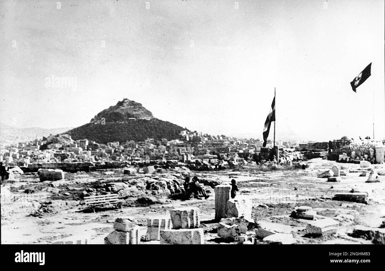 The Nazi flag with its swastika symbol, right, flies beside the flag of ...