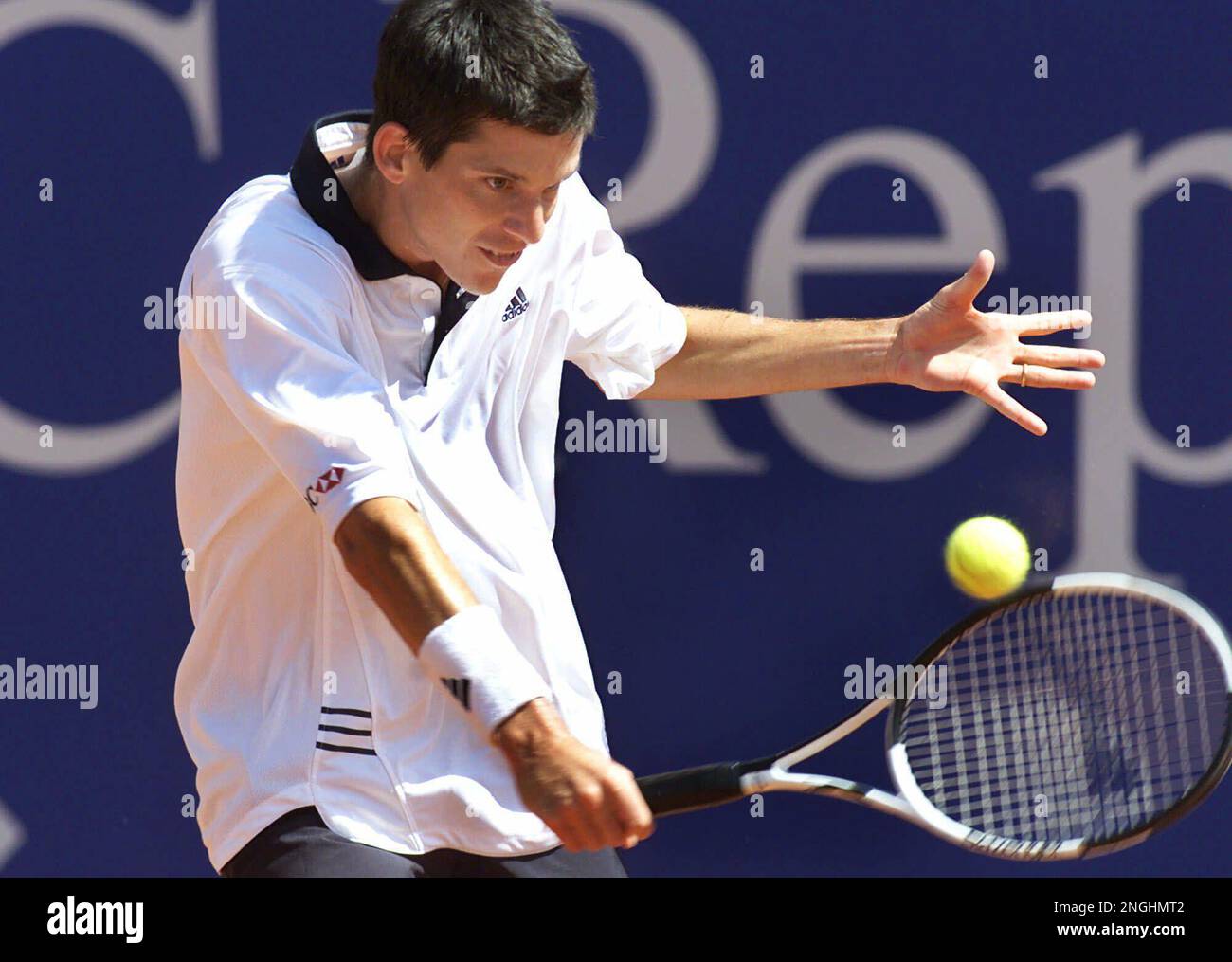 British player Tim Henman hits the ball against Argentina's Gaston ...