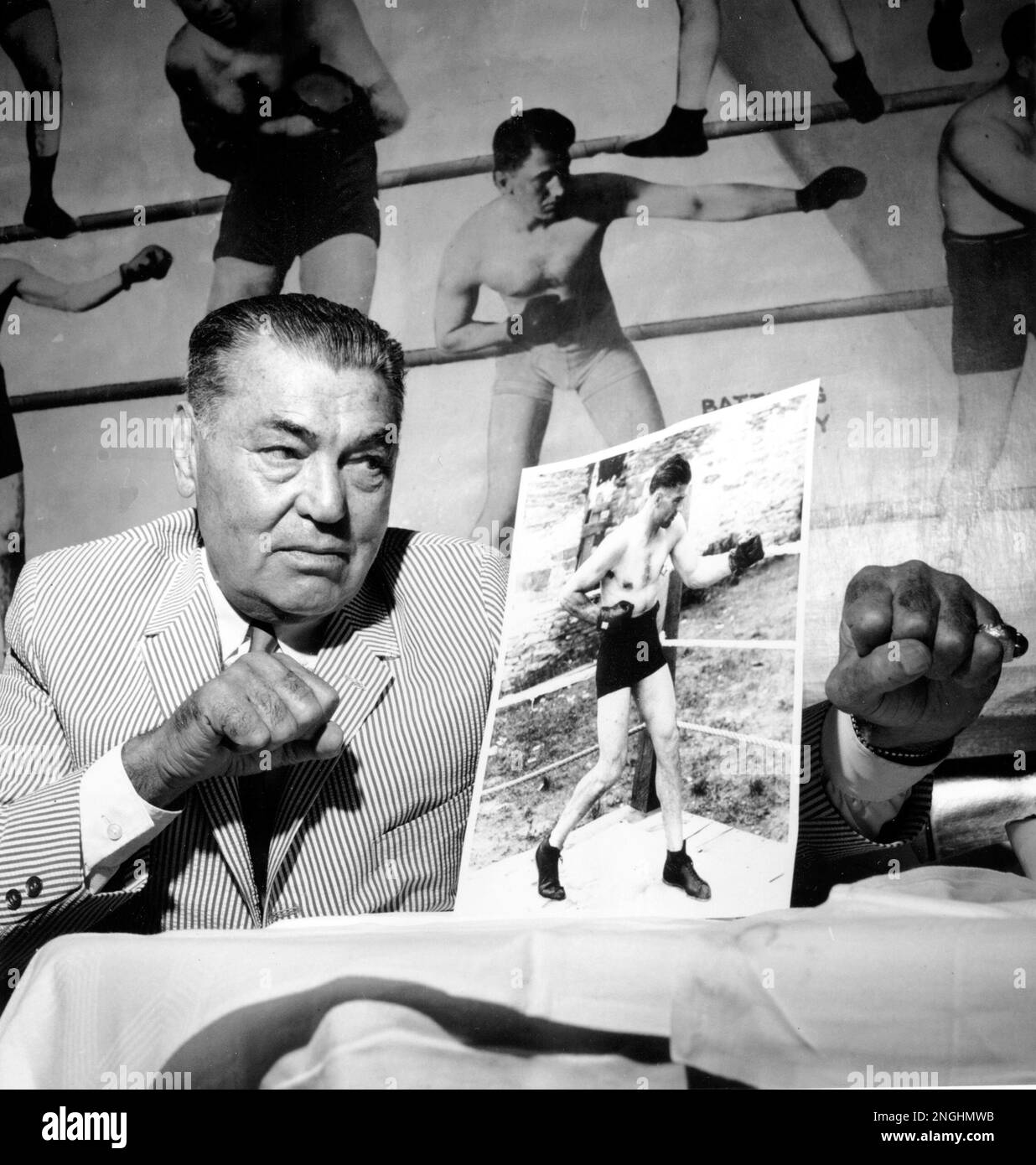Former heavyweight champion Jack Dempsey poses with a photograph ...