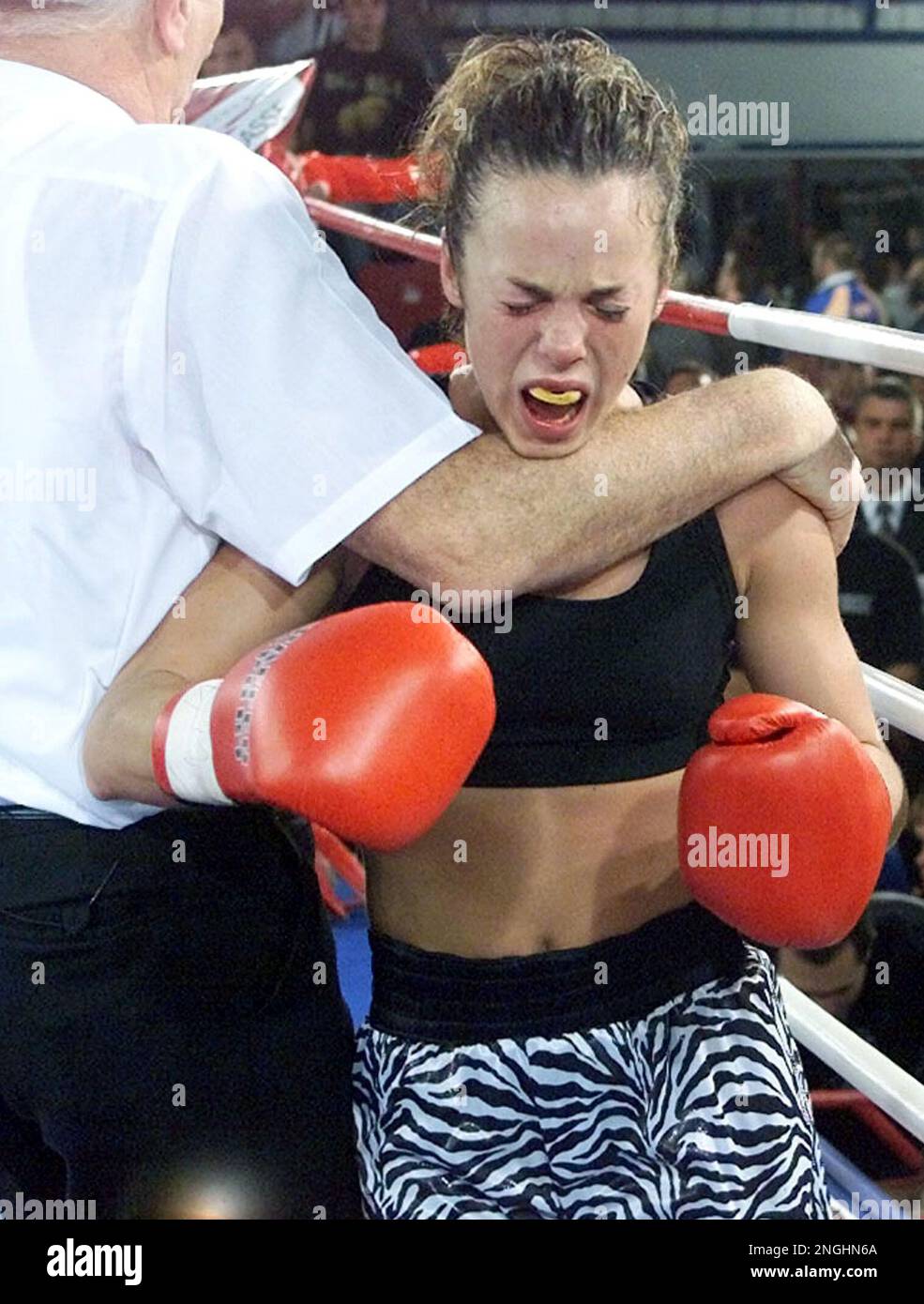 The referee holds U.S. boxer Andrea Blevins after she was hit by German ...