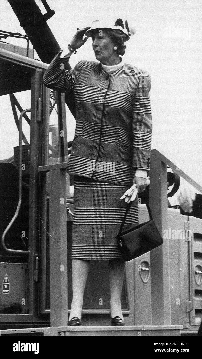 British Prime Minister Margaret Thatcher adjusts her hard hat at the ...