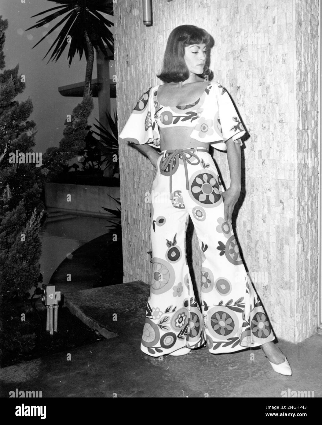 Model Dale Kole wears bell-bottom pants and a matching midriff halter ...