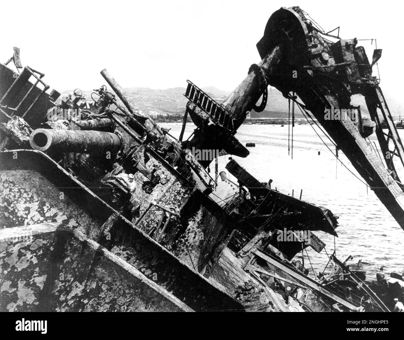 As the deck of the capsized battleship USS Oklahoma breaks water ...