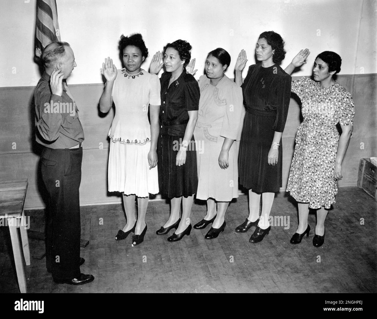 Lt. James L. Munson administers the oath to five black American women ...