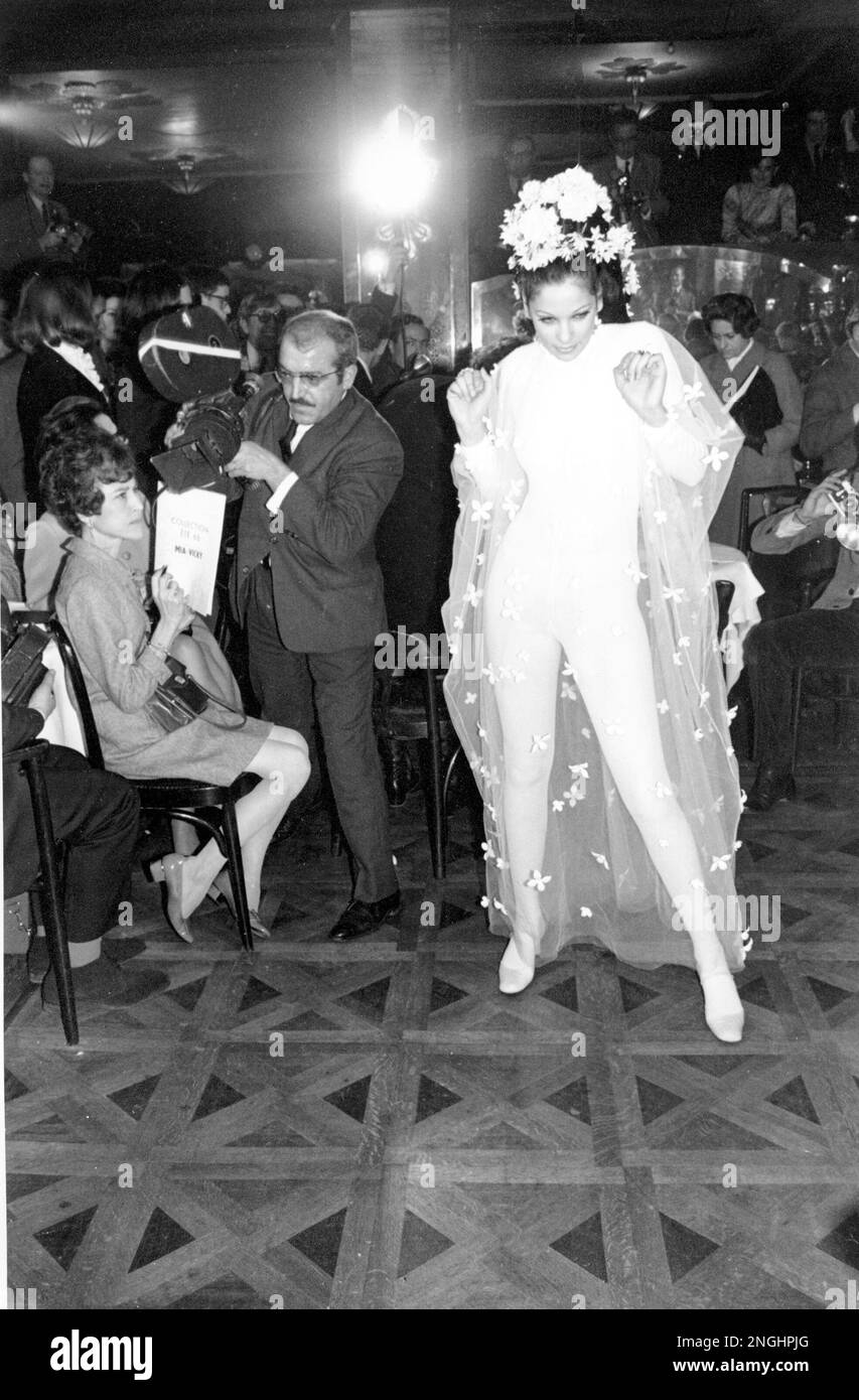 A wedding gown of tulle dotted with jasmine flowers is presented at Mia ...