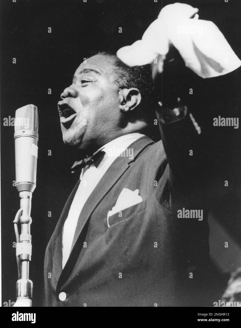 American jazz musician Louis Armstrong, nicknamed Satchmo, brings down ...