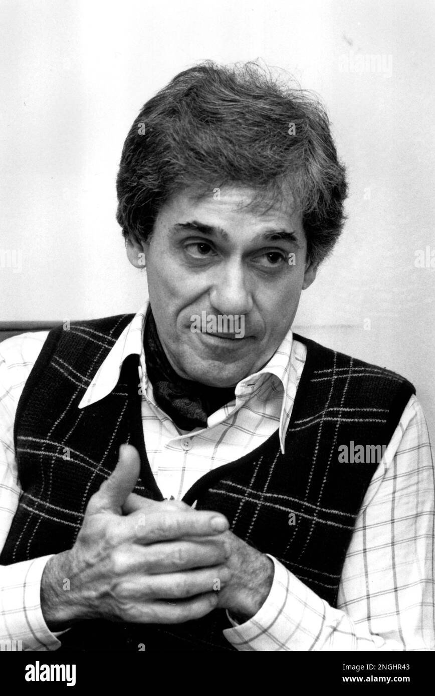 Choreographer Peter Gennaro gestures as he answers questions backstage ...