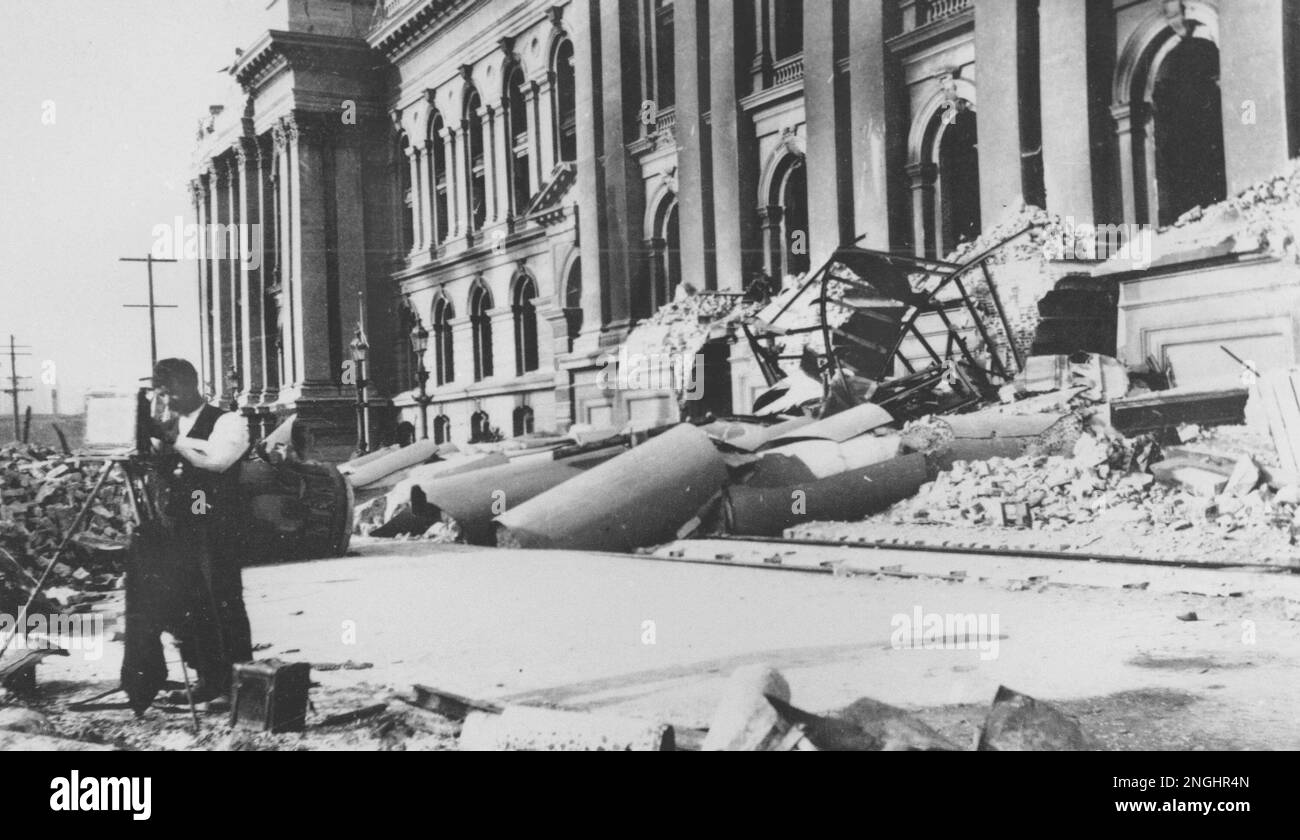 A photographer in front of City Hall takes photos of the disaster ...