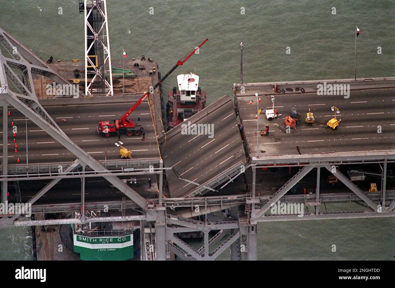 A crane mounted on a barge, left, has been towed into position, ready ...