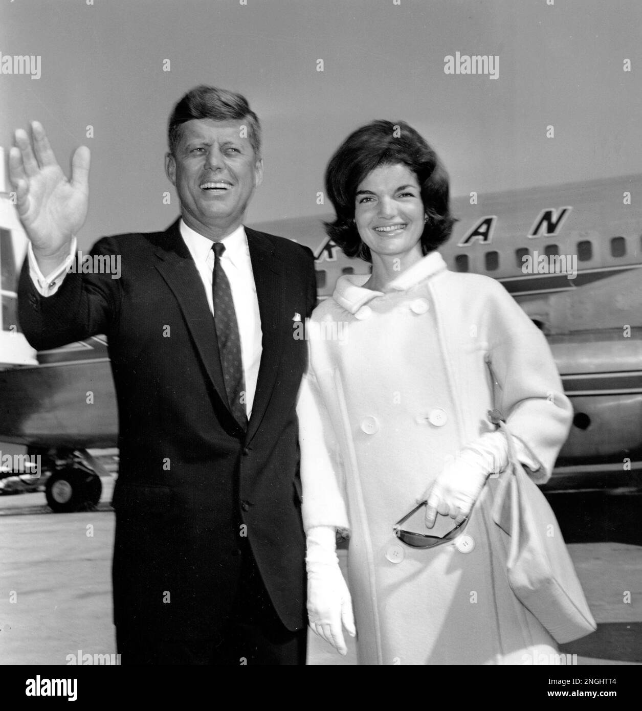 Sen. John F. Kennedy waves farewell as he poses with his wife ...