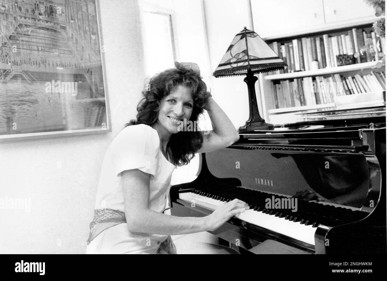 Lucy Simon sits at the piano in her New York apartment on May 28, 1982 ...