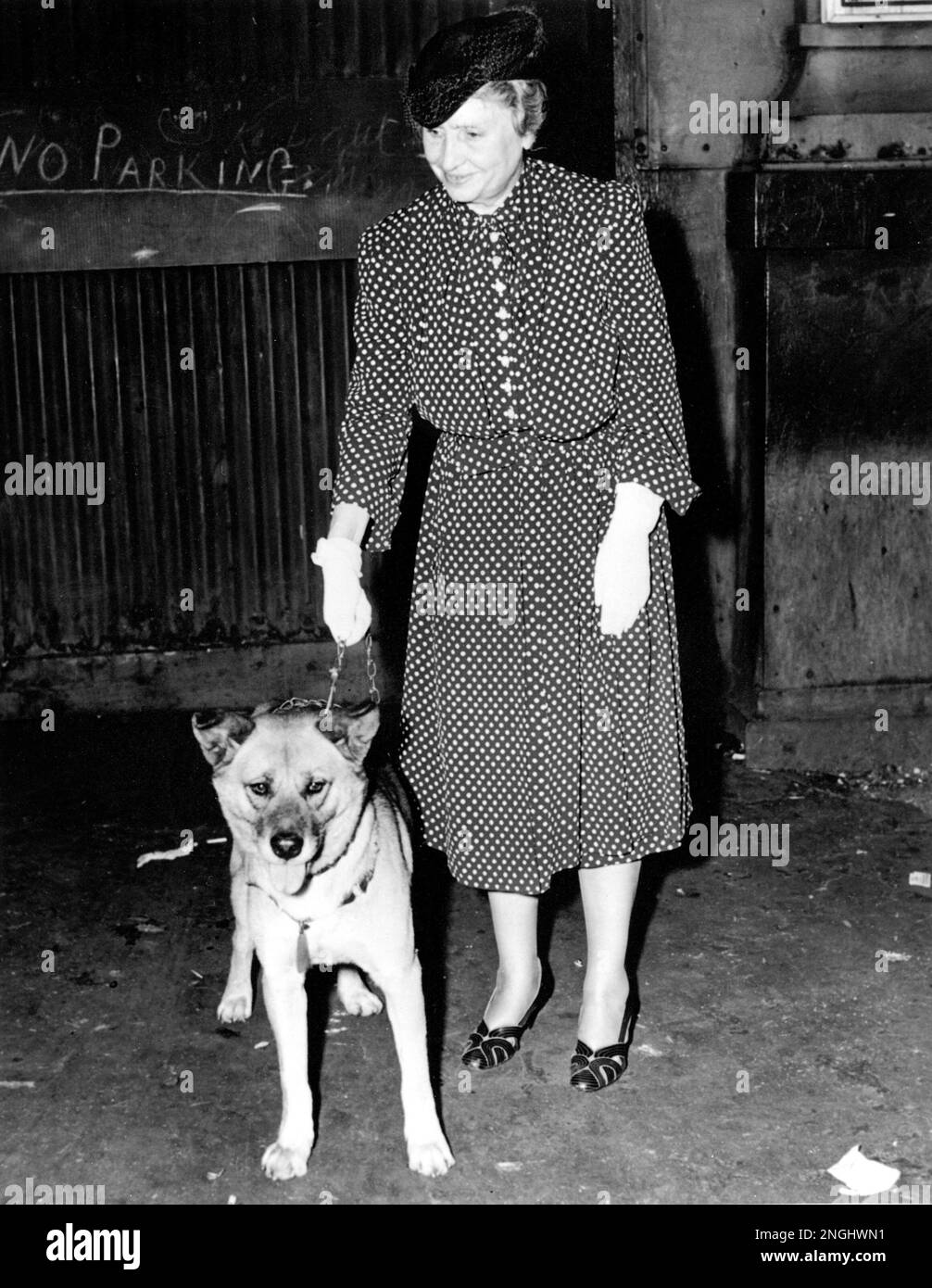 Helen Keller, who is blind and deaf, is led from the pier by her new ...