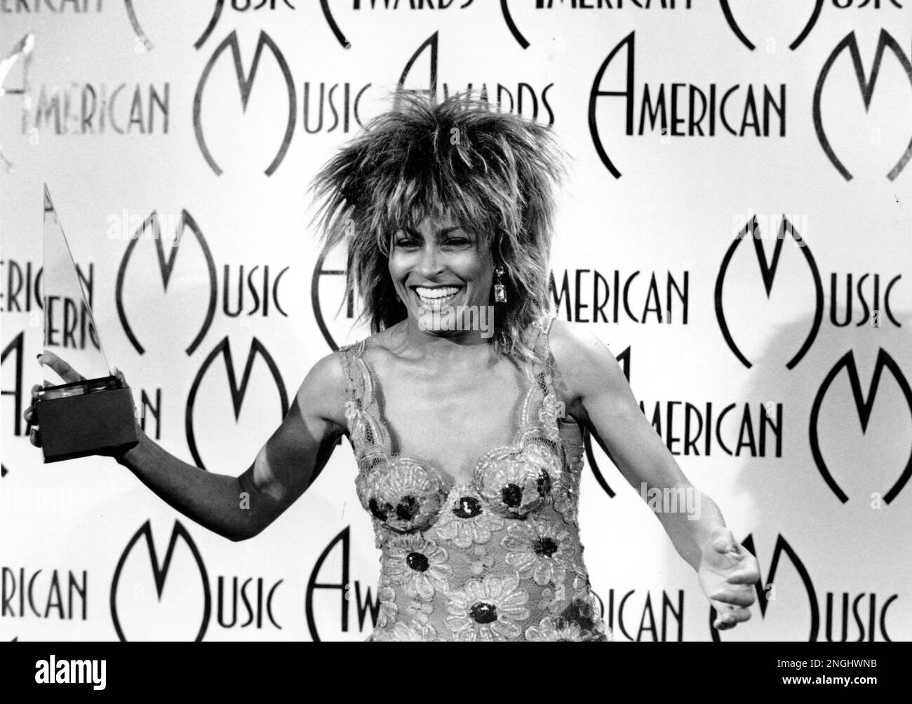 Pop vocalist Tina Turner smiles as she waves her award backstage at the ...