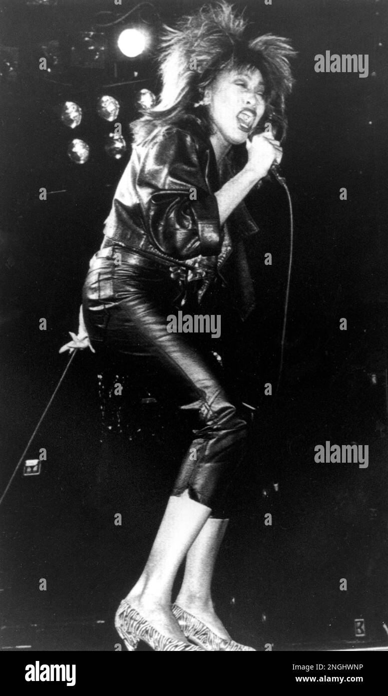 American singer Tina Turner, wearing black leather, sings on stage at ...