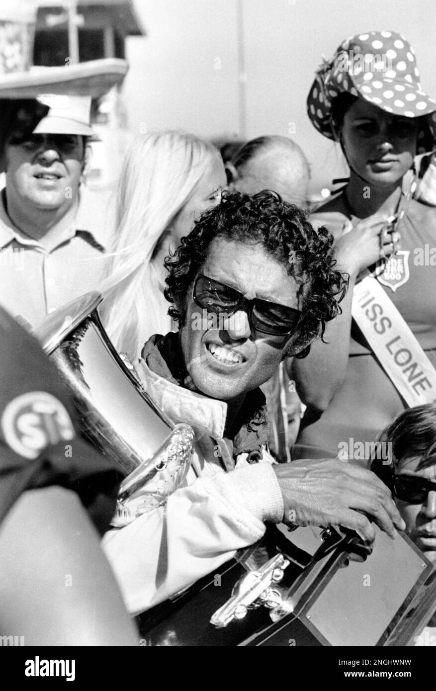 Stock car racer Richard Petty hugs his trophy after winning the Lone ...