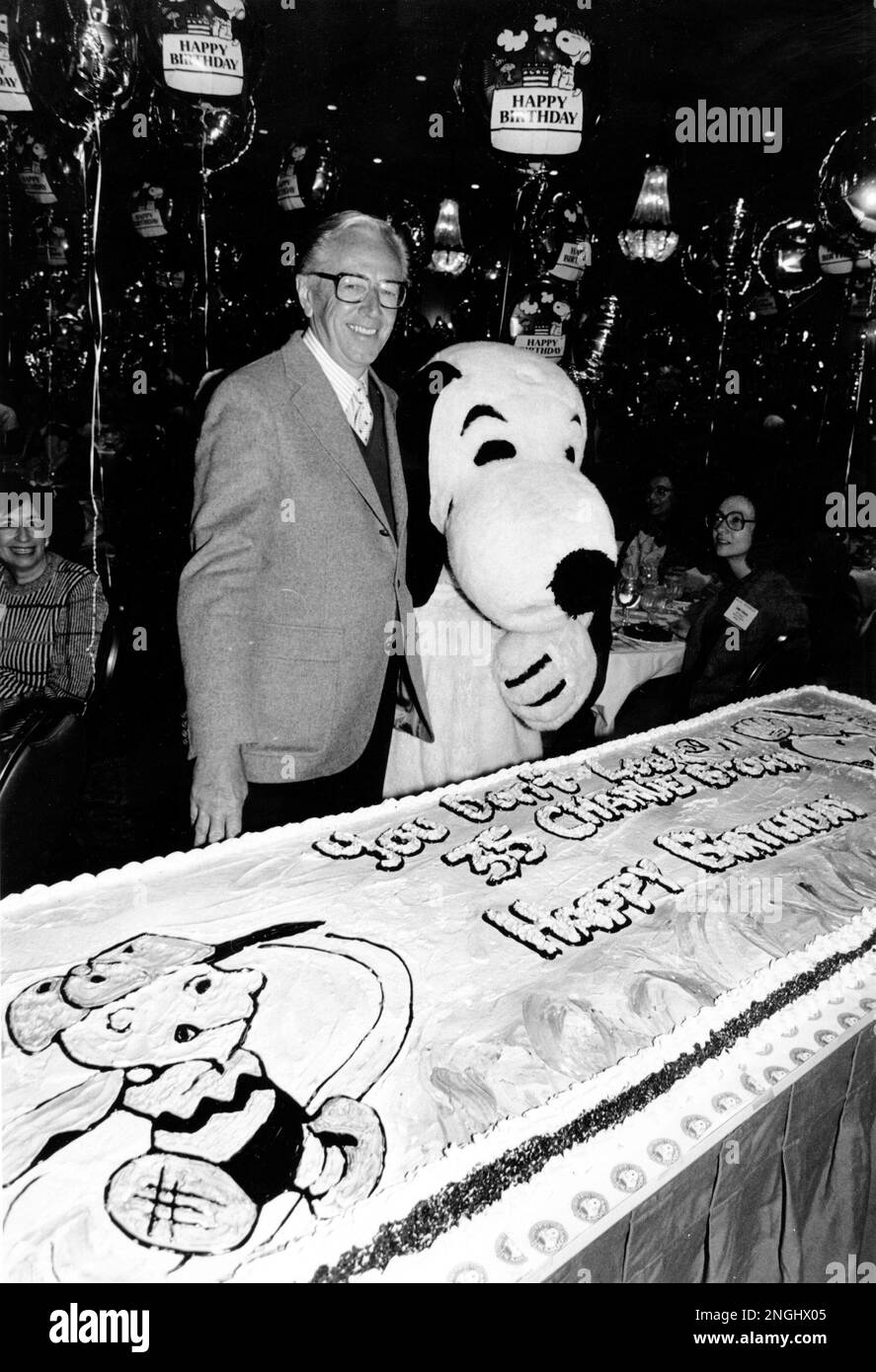 Charles M. Schulz, creator of the "Peanuts" gang, poses with Snoopy in ...