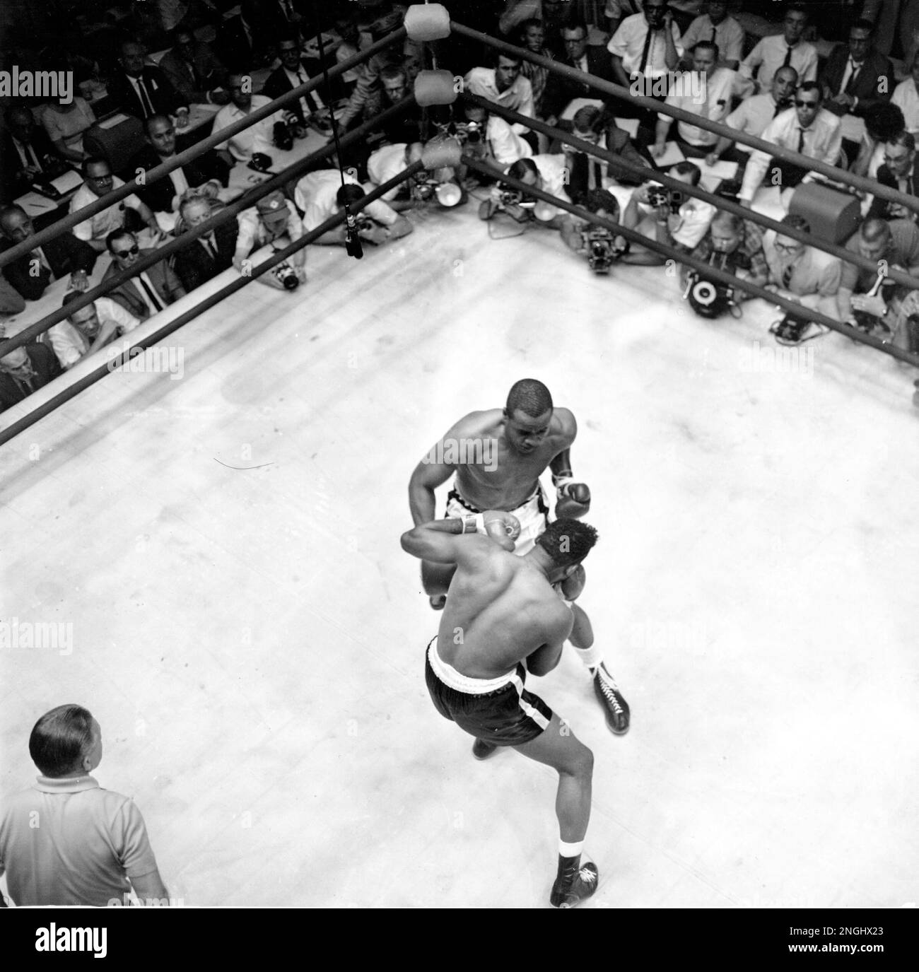 World heavyweight champion Sonny Liston, top, staggers Floyd Patterson ...