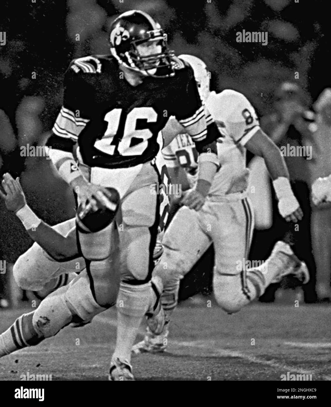 Iowa quarterback Chuck Long looks for a receiver as he rolls out during ...