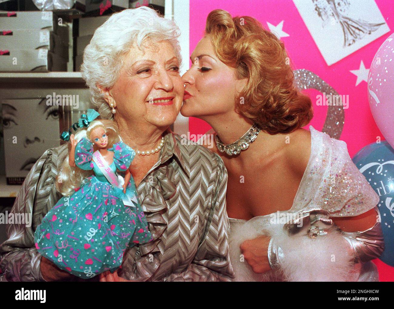 Barbie doll creator Ruth Handler, left, gets a kiss from Kristi Cooke ...