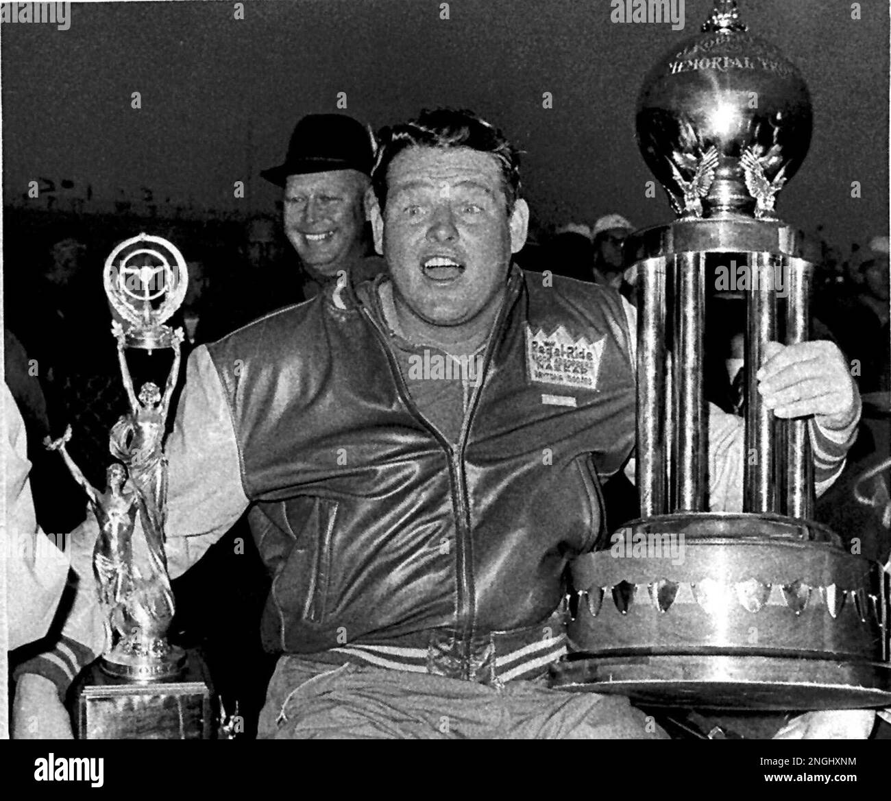 Tiny Lund, of Cross, S.C. yells at a friend as he holds two trophies ...