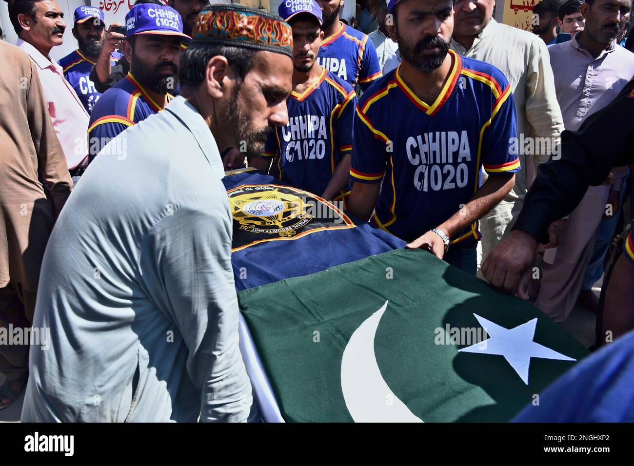 Volunteers load the casket of a police officer, who was killed in a ...