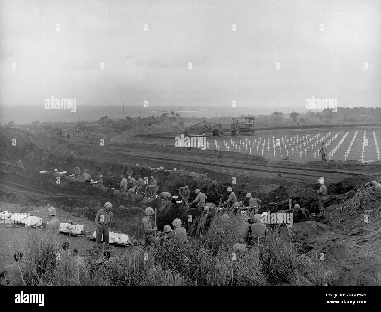 This is a March, 1945 photo of U.S. Marines digging graves in the ...