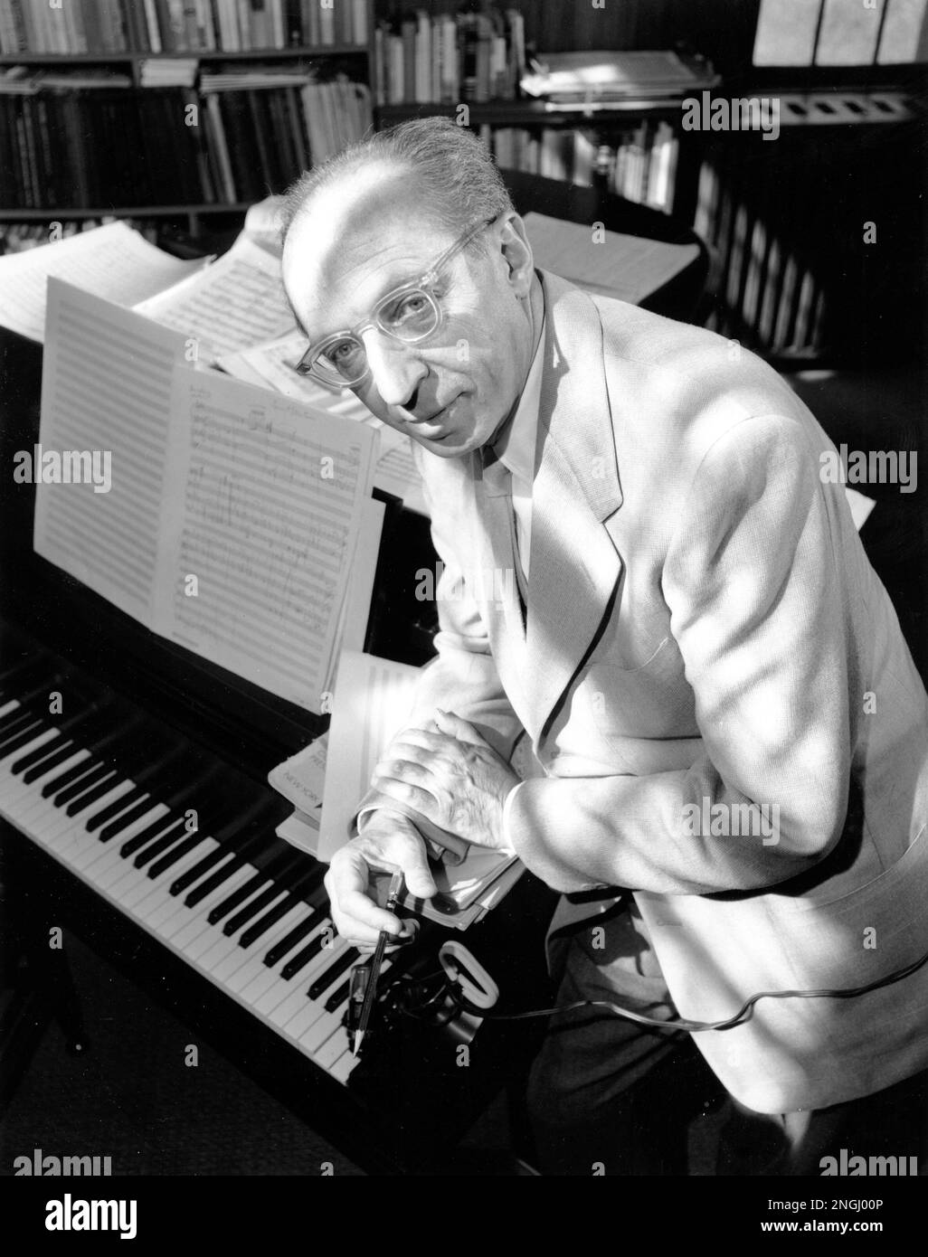 American composer Aaron Copland leans on his piano at his home in ...