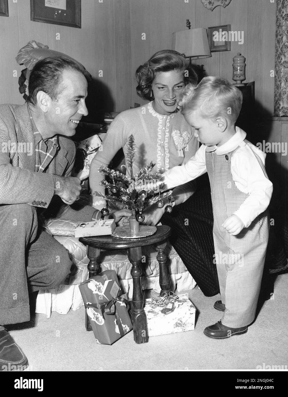 Actor Humphrey Bogart and his wife, actress Lauren Bacall, help their ...