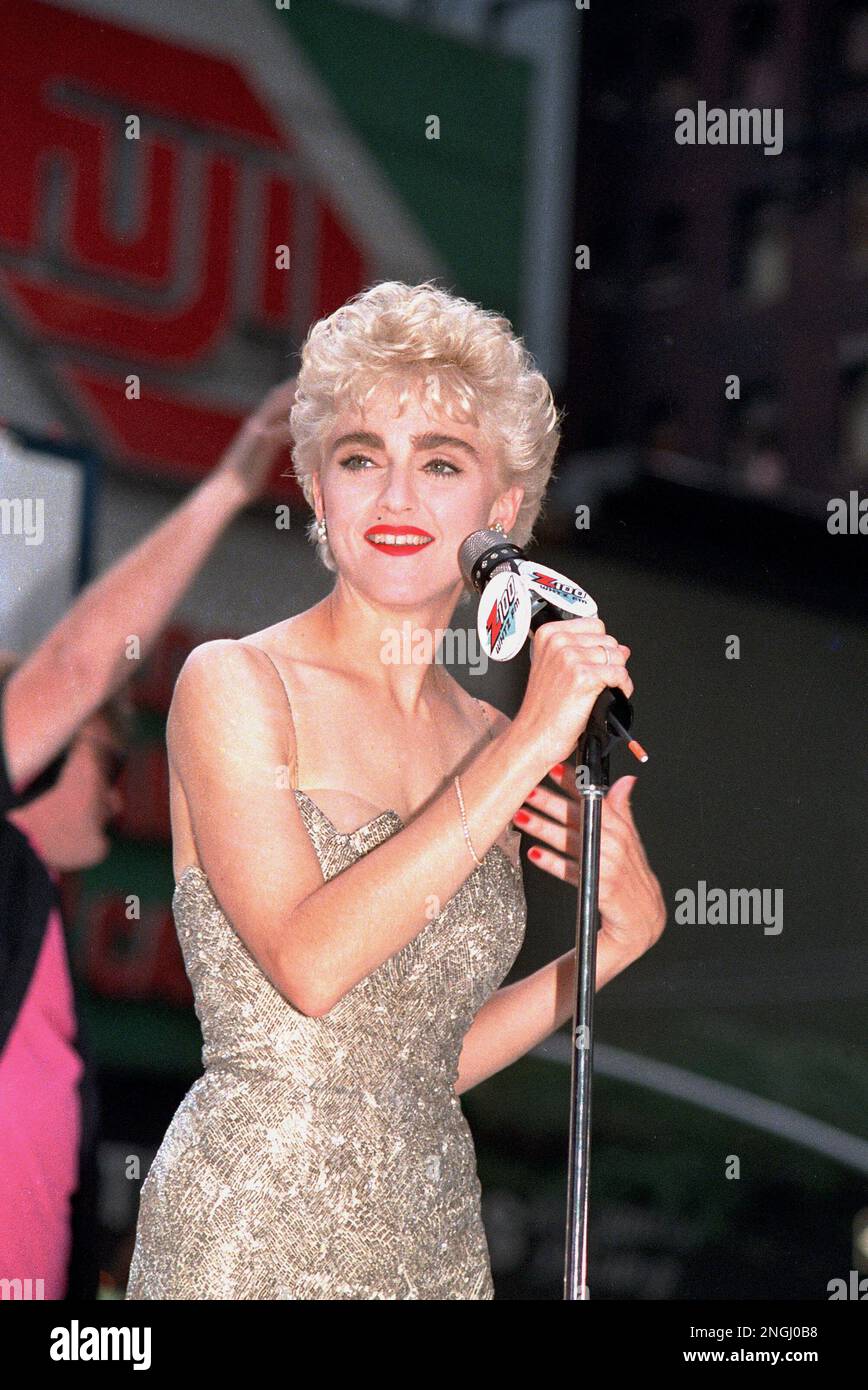 Pop singer Madonna greets her fans from a platform in Times Square in ...