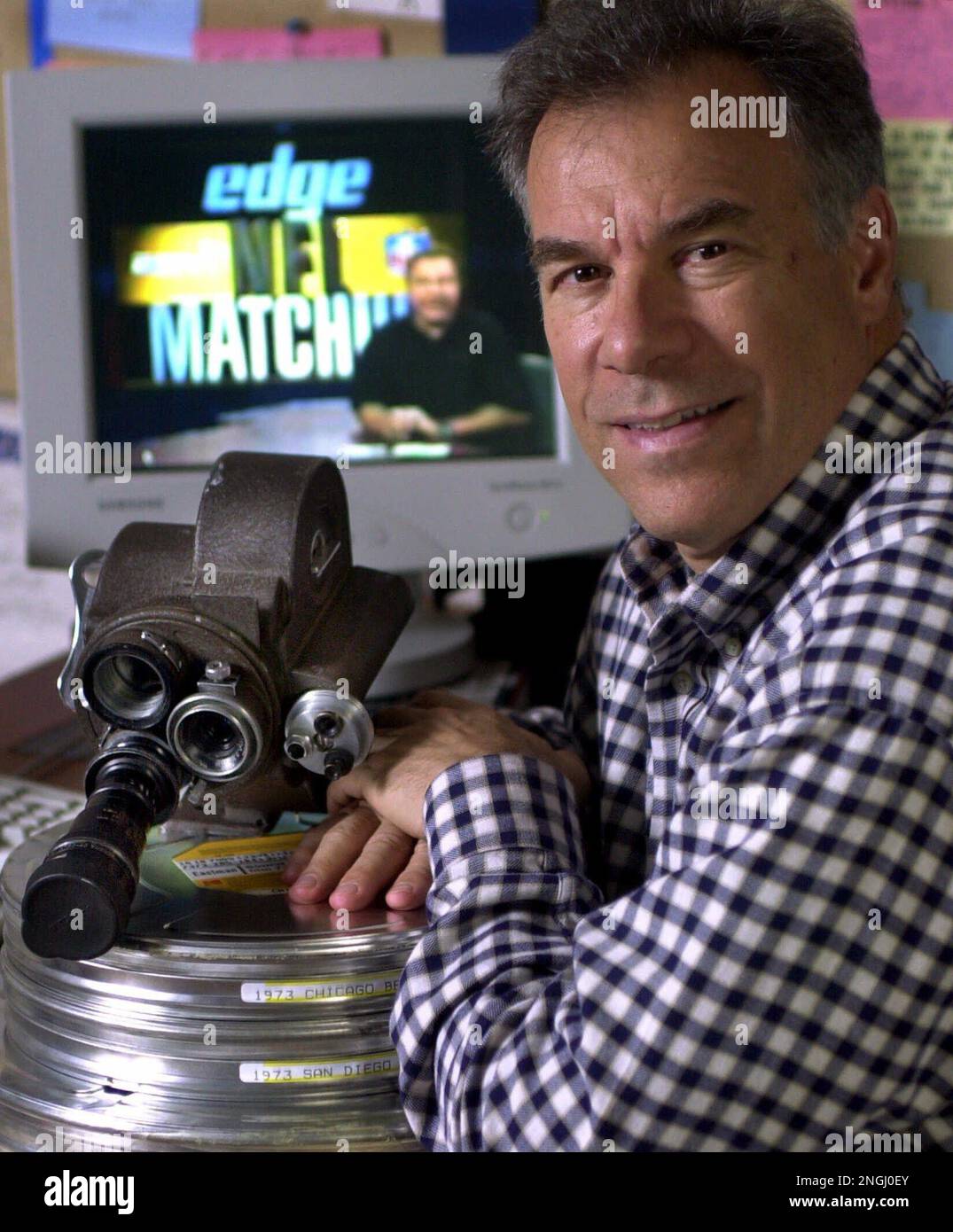 NFL Films President Steve Sabol poses at his desk with an old 16mm ...