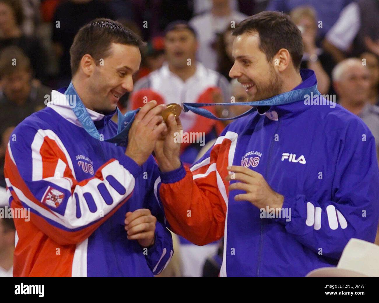Vladimir Batez, left, clinks gold medals with teammate Goran Vujevic ...
