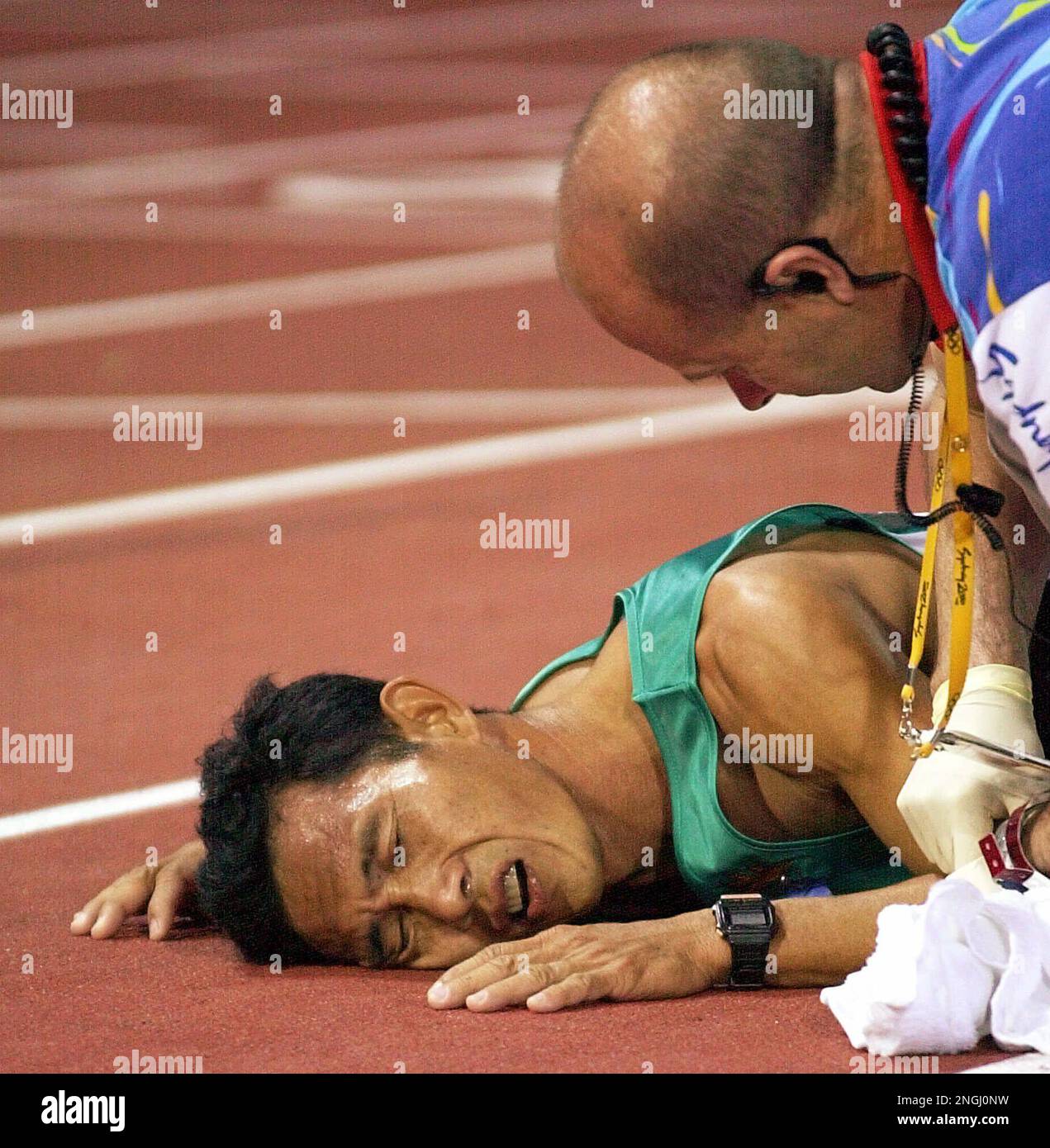 Cambodia's Rithya To is attended to by a track official after he ...