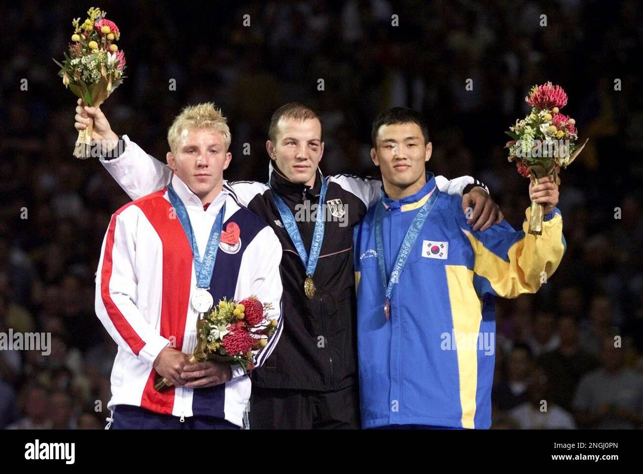 USA's Brandon Slay, left, holding his silver medal for the 76 kg ...
