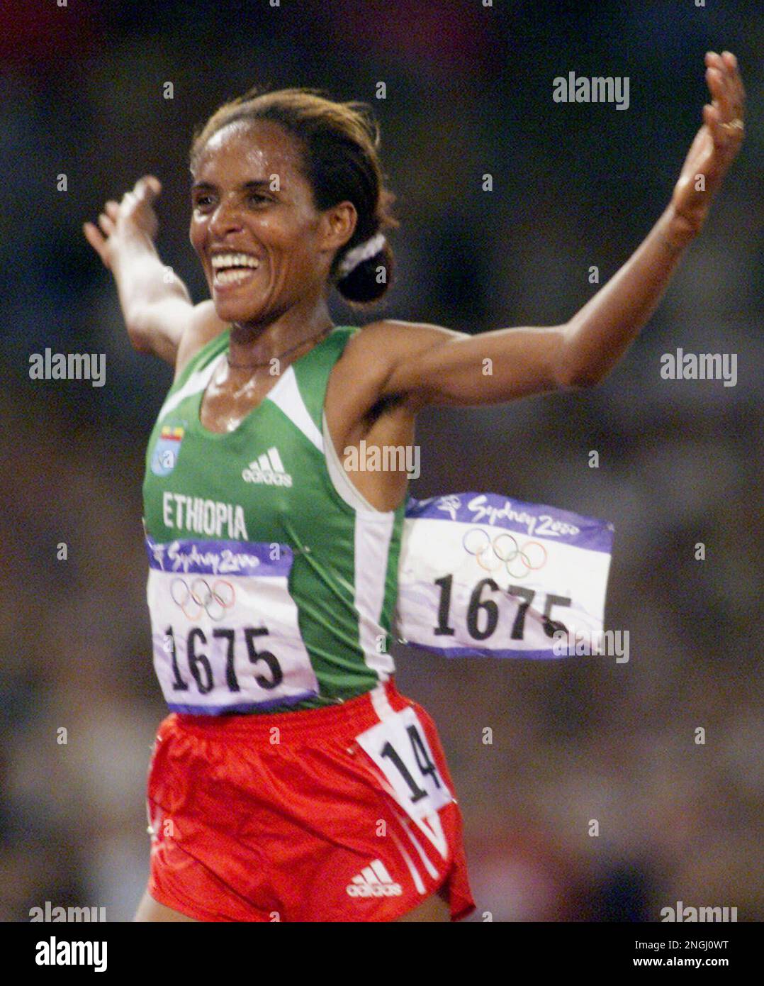 Ethiopia's Derartu Tulu reacts after crossing the finish line to win ...