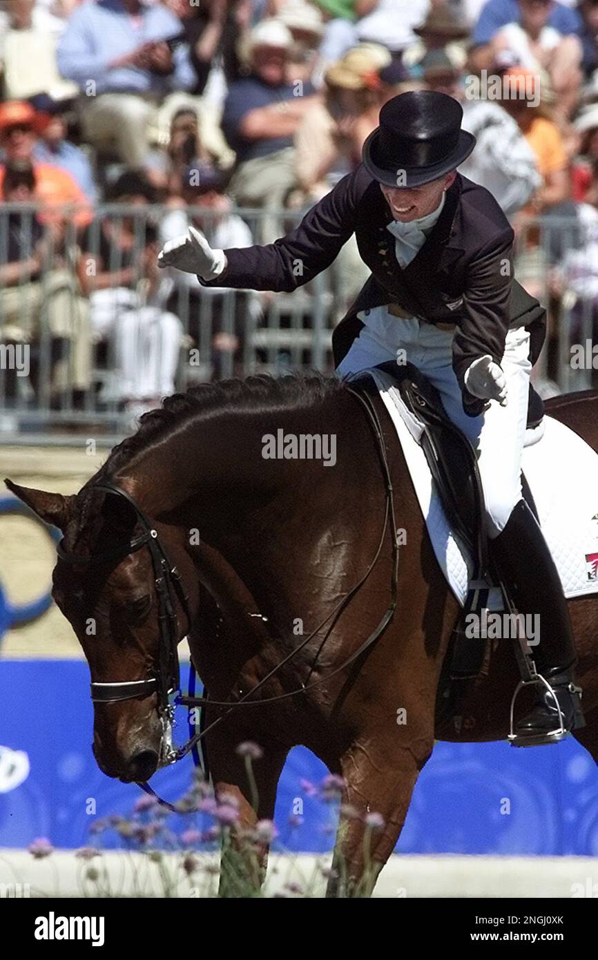 The Netherland's Anky van Grunsven pats her horse, Bonfire, after ...