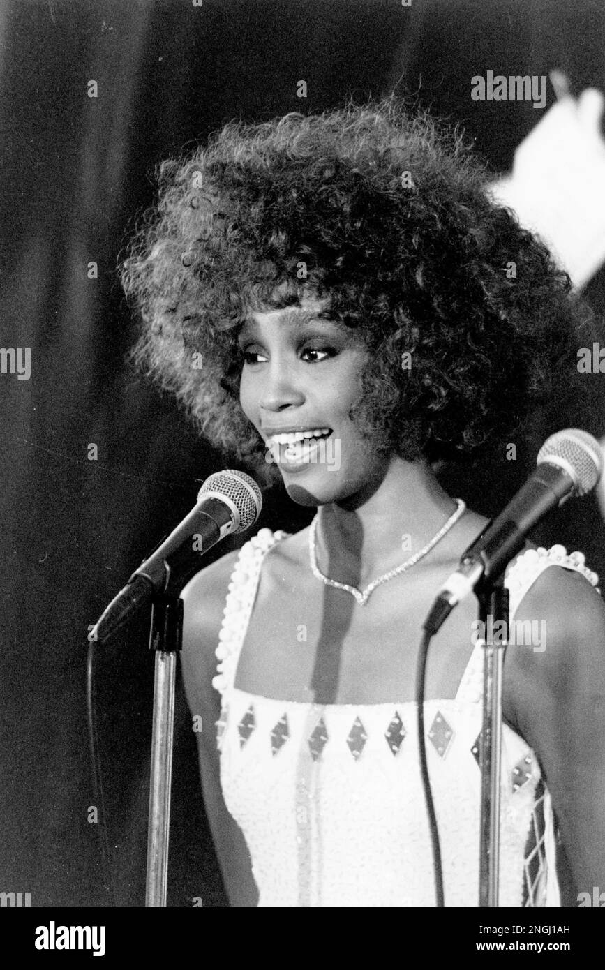 American singer Whitney Houston talks to the press following the third ...