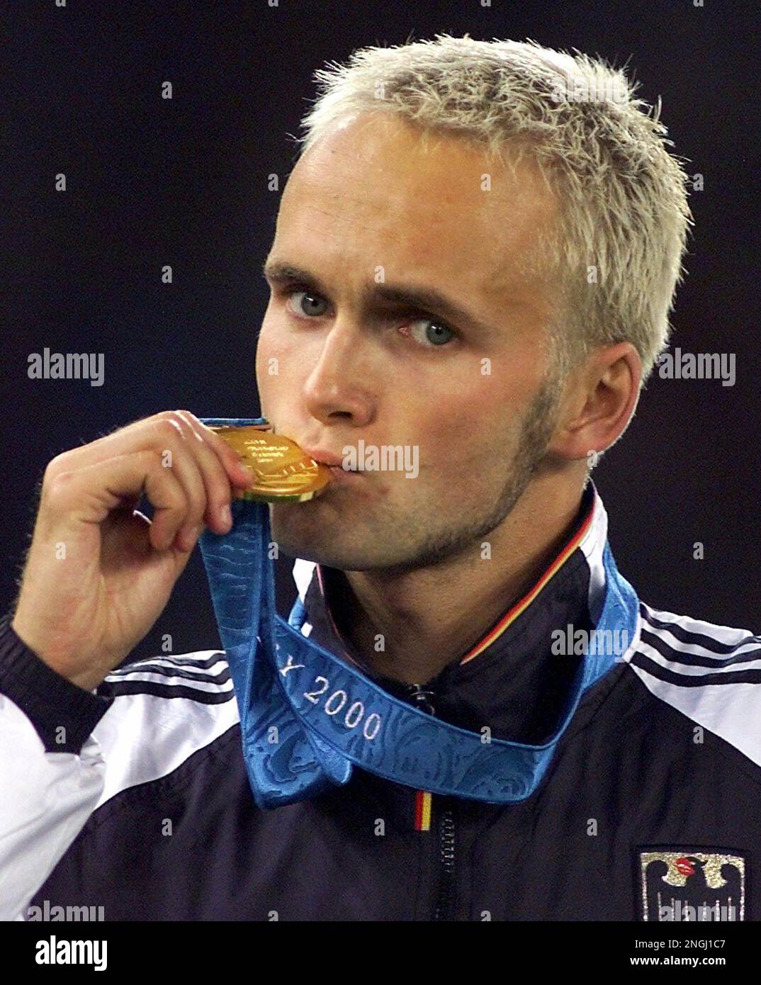 German sprinter Nils Schumann kisses his gold medal for the men's 800 ...