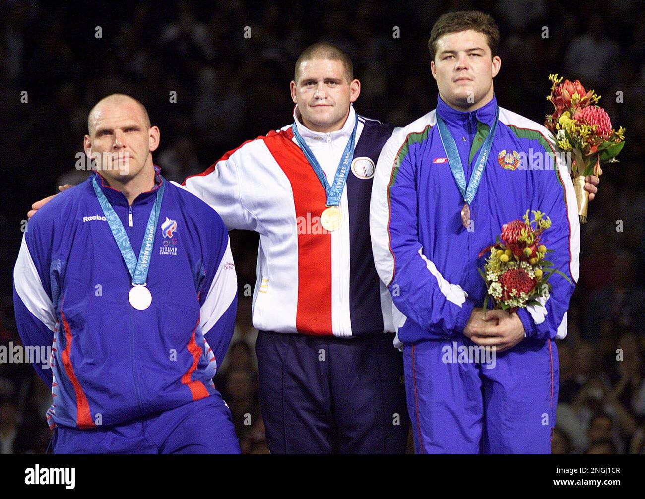 Greco-Roman wrestling gold medalist USA's Rulon Gardner, center, puts ...